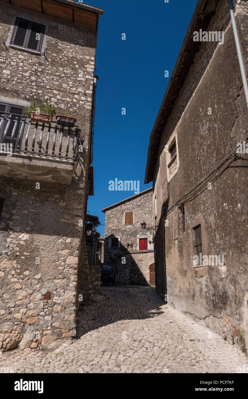 Medieval town street view with a red wooden window on the background ...
