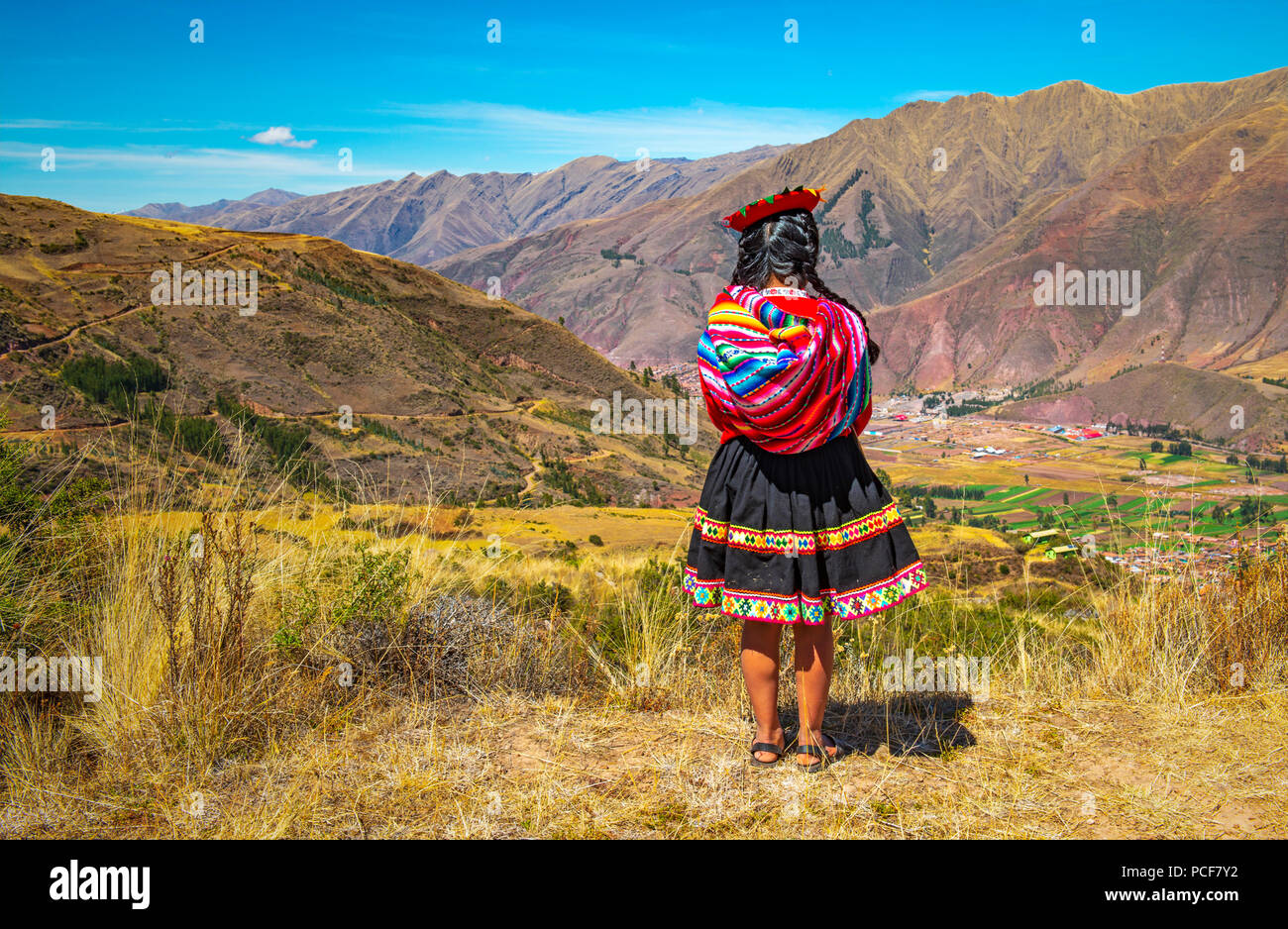 Indigenous Quechua lady in traditional clothing (skirt, hat and textile ...