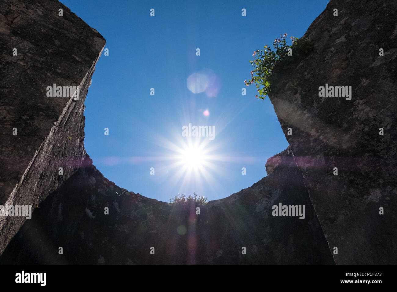 Shinny sun with flare in blue sky from medieval walls Stock Photo - Alamy
