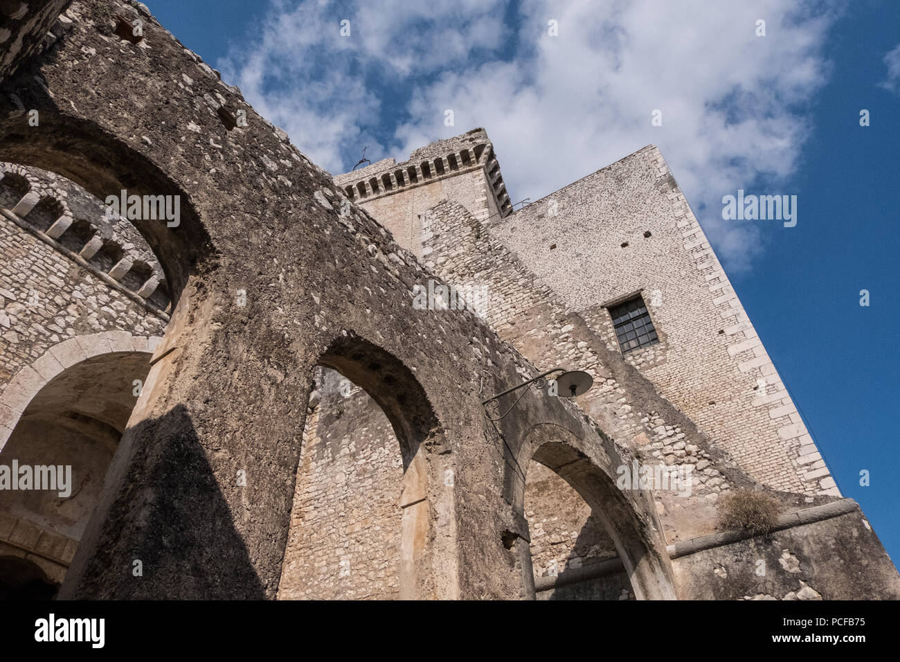 Arches of an ancient medieval castle with blue sky and clouds ...