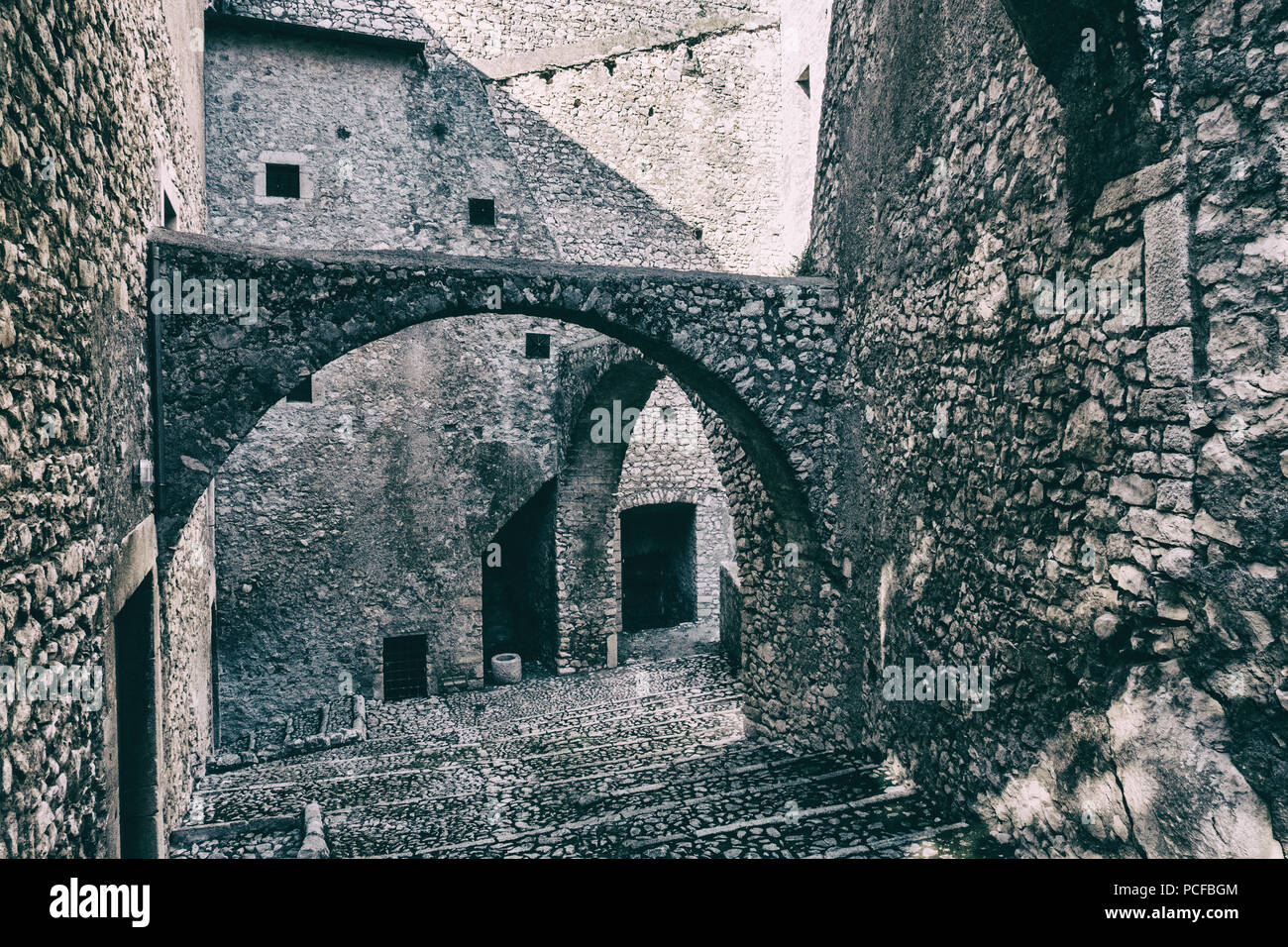 Arches and stairs of a medieval stone wall castle Stock Photo - Alamy