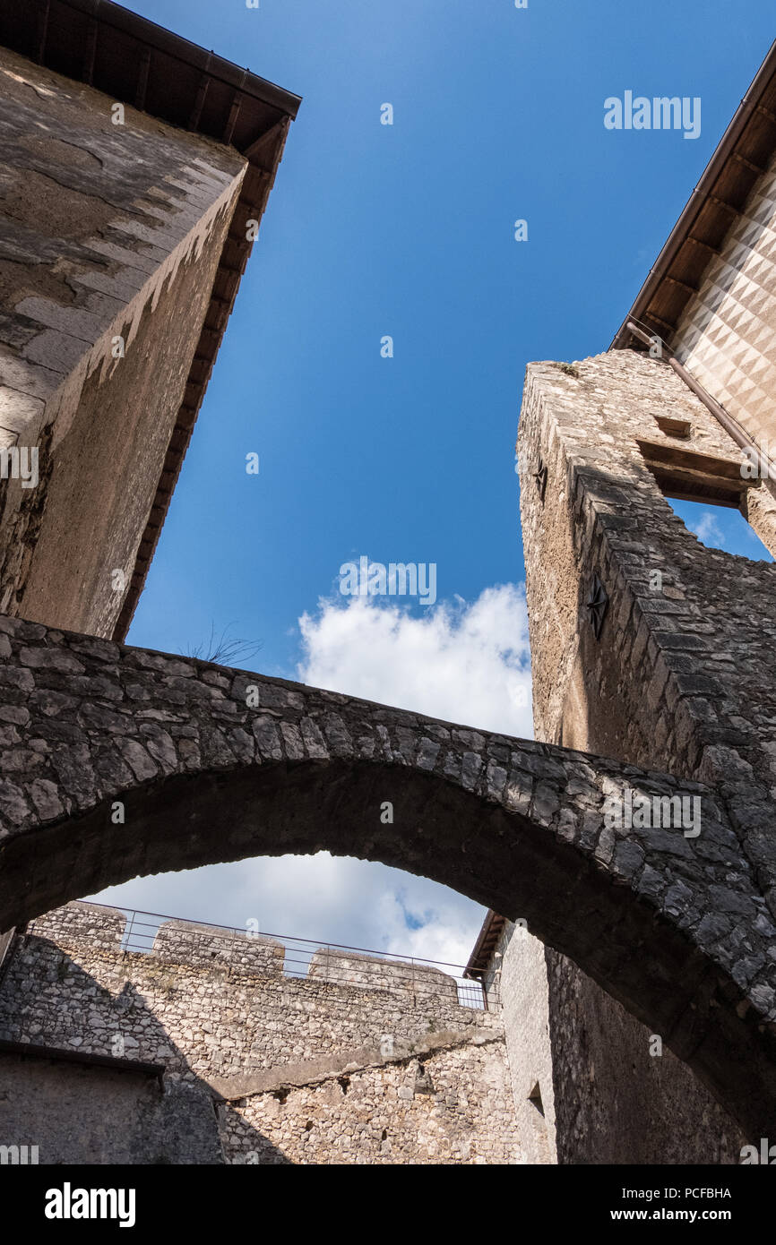 Vertical low angle view of arches of a medieval castle with blue sky ...