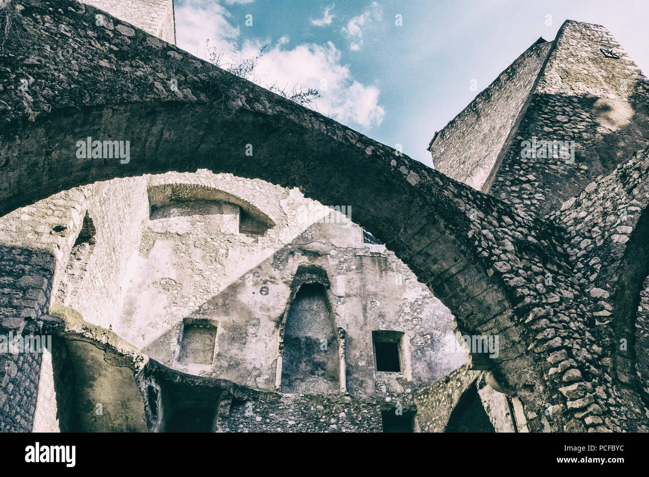 Low angle view of a medieval stone worn wall castle with blue sky ...