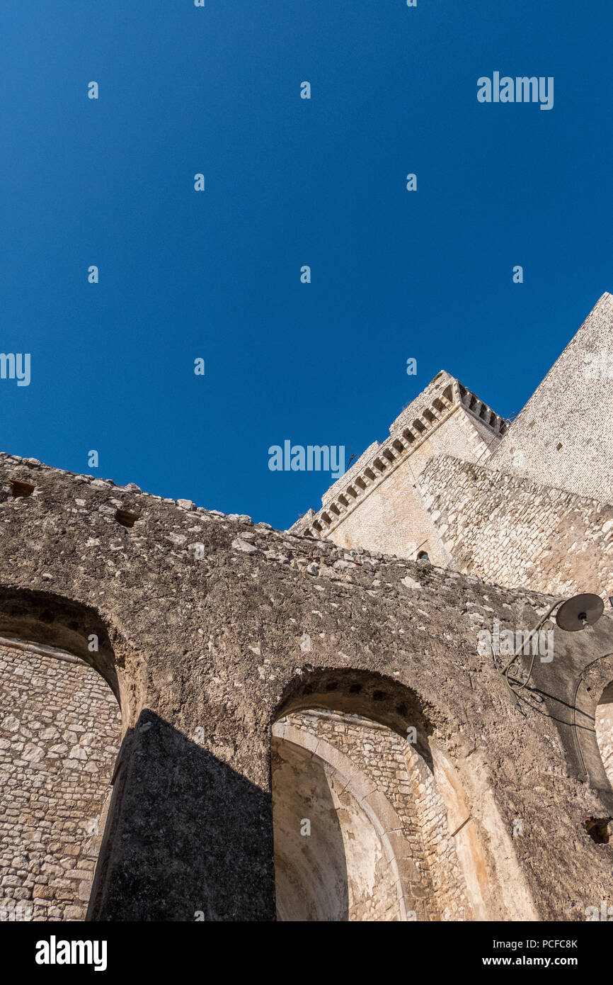 Vertical photo of medieval castle construction with blue sky background ...