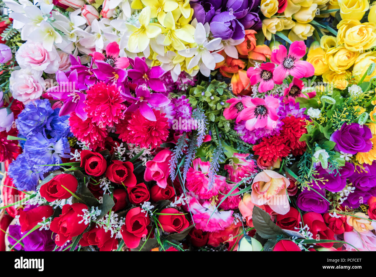 Vivid multicolored plastic flower wallpaper background Stock Photo - Alamy
