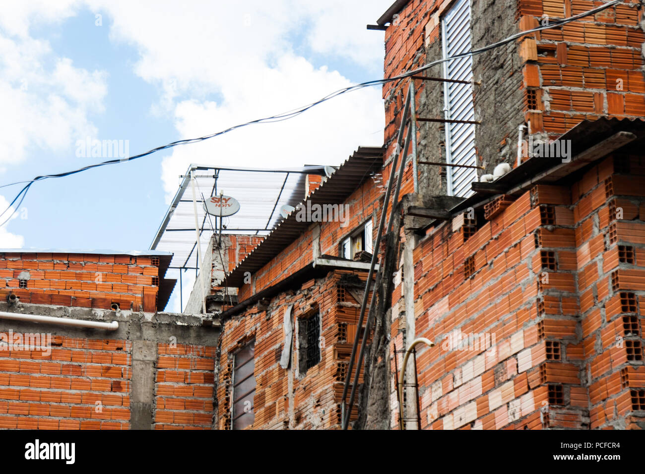Orange worn brick houses of a favela in Brazil Stock Photo - Alamy