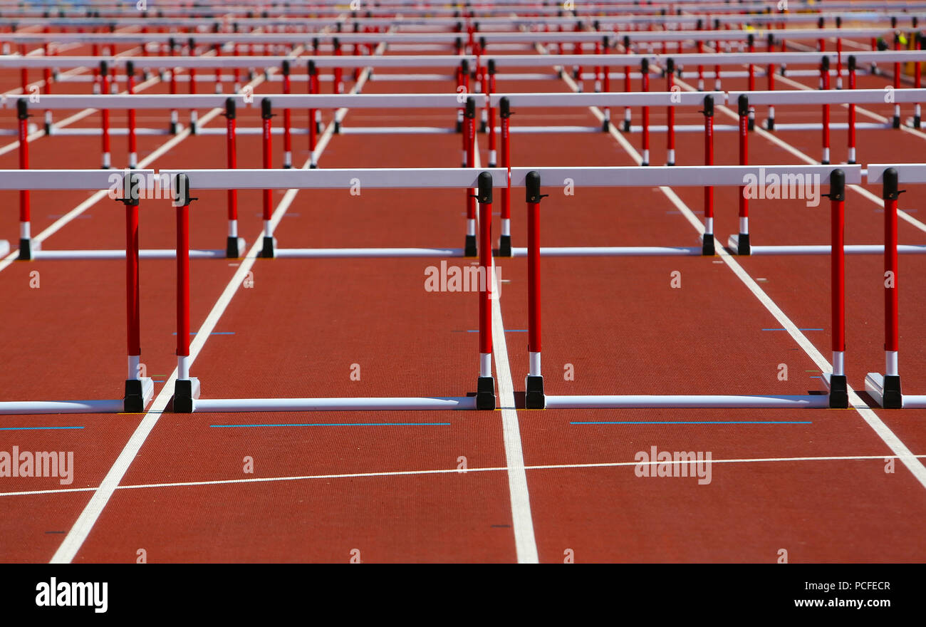 Hurdles on competition background Stock Photo - Alamy