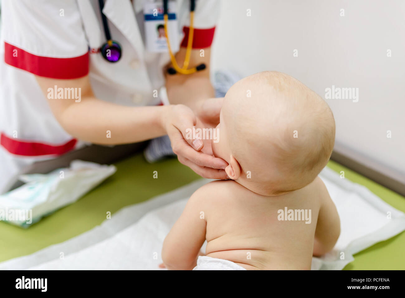 Little cute baby boy visiting doctor . Pediatrician make check up and ...