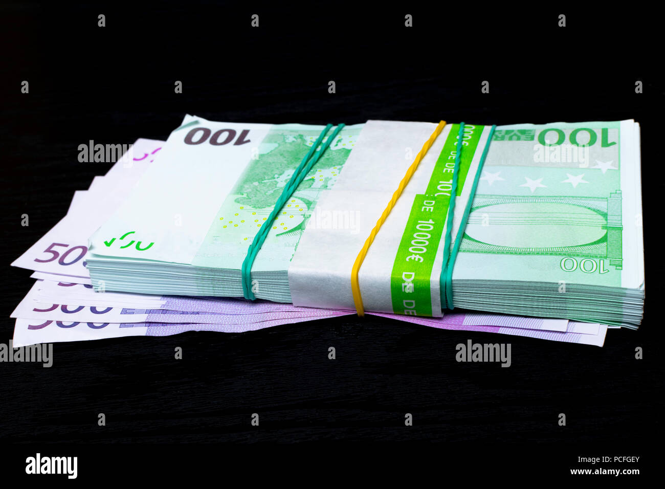 Euros money stack isolated on black background Stock Photo - Alamy