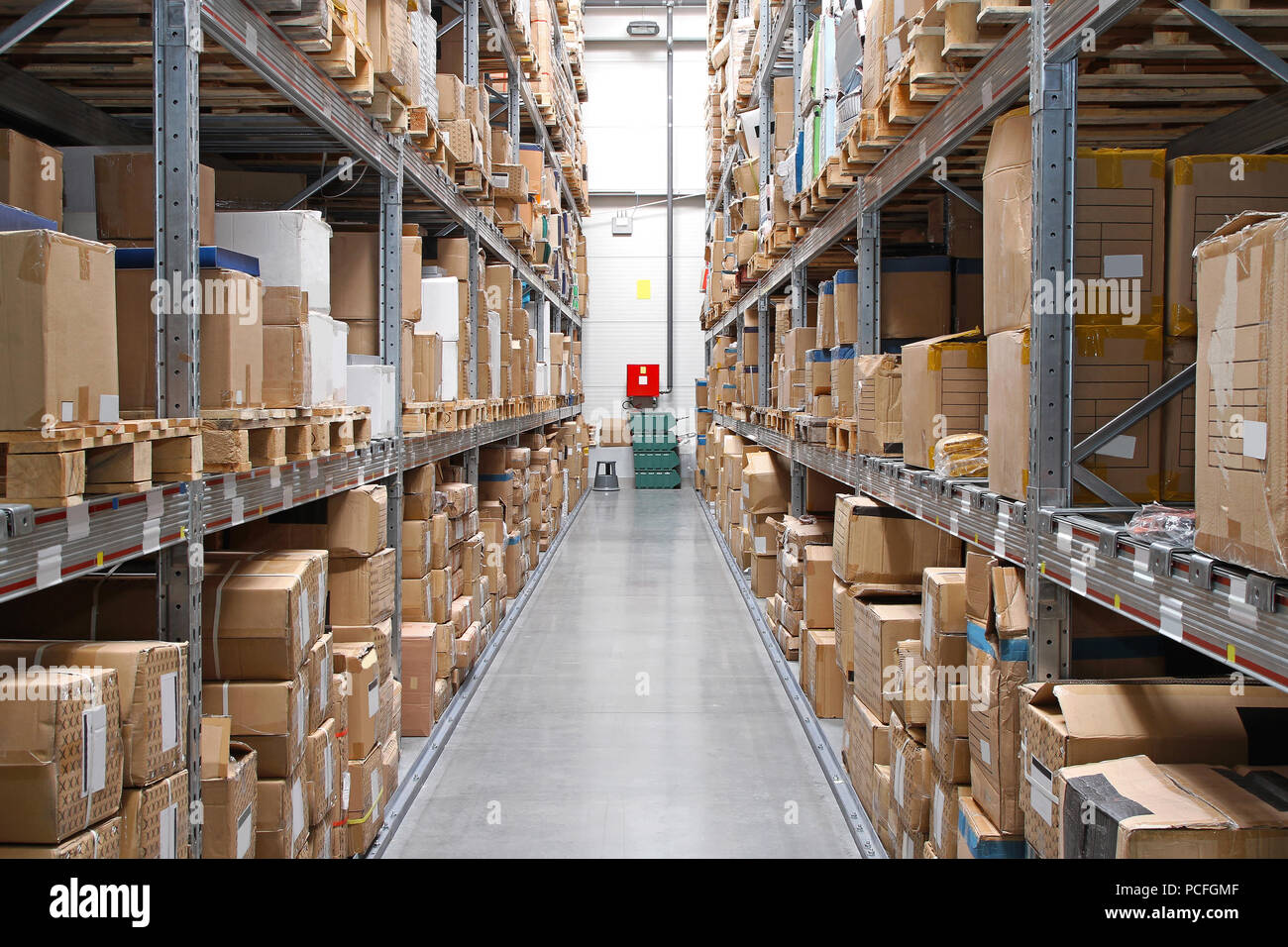 Warehouse rows with cardboard boxes and goods at shelves Stock Photo ...