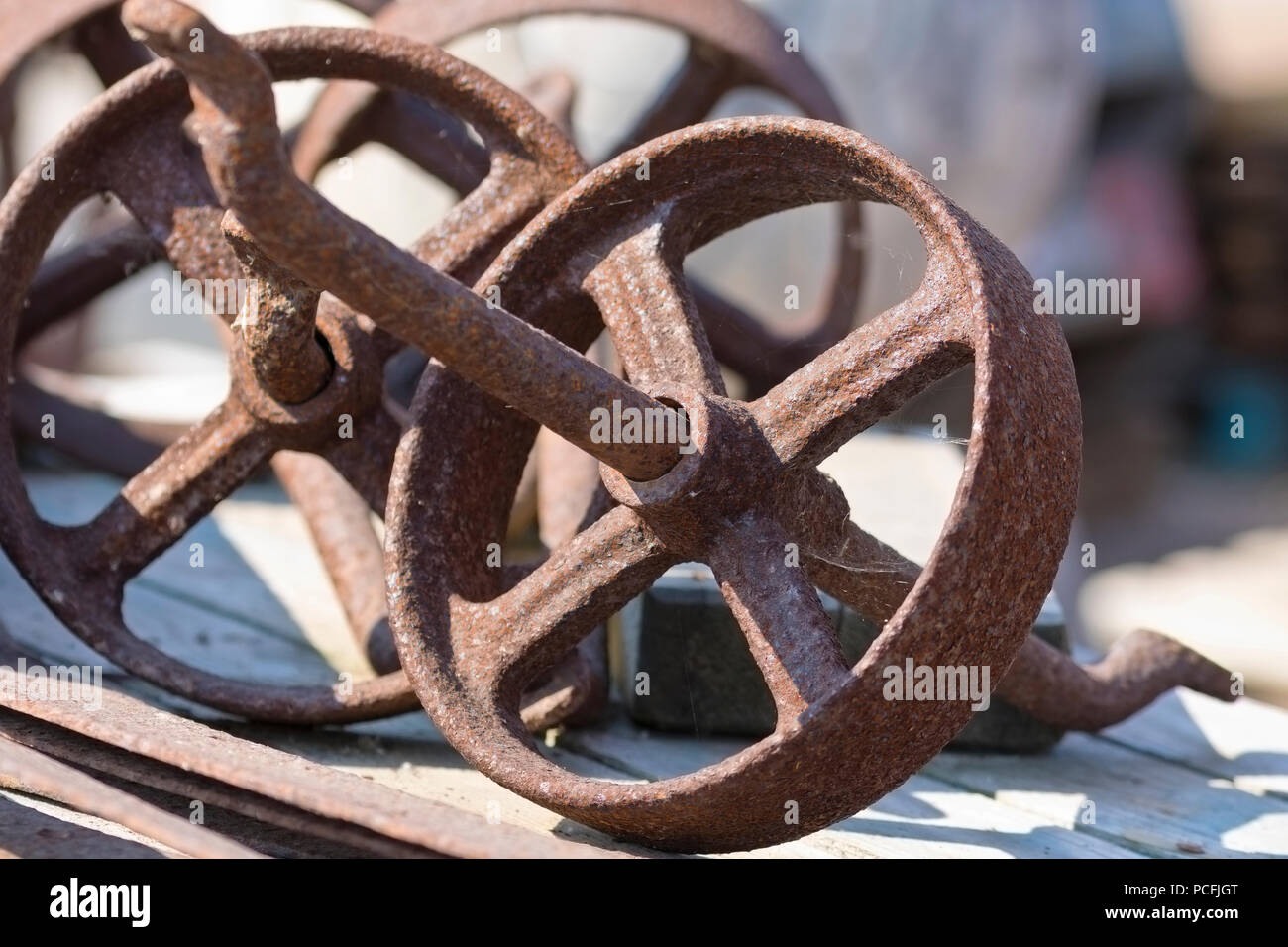 Reclaimed, aged iron wheels Stock Photo - Alamy