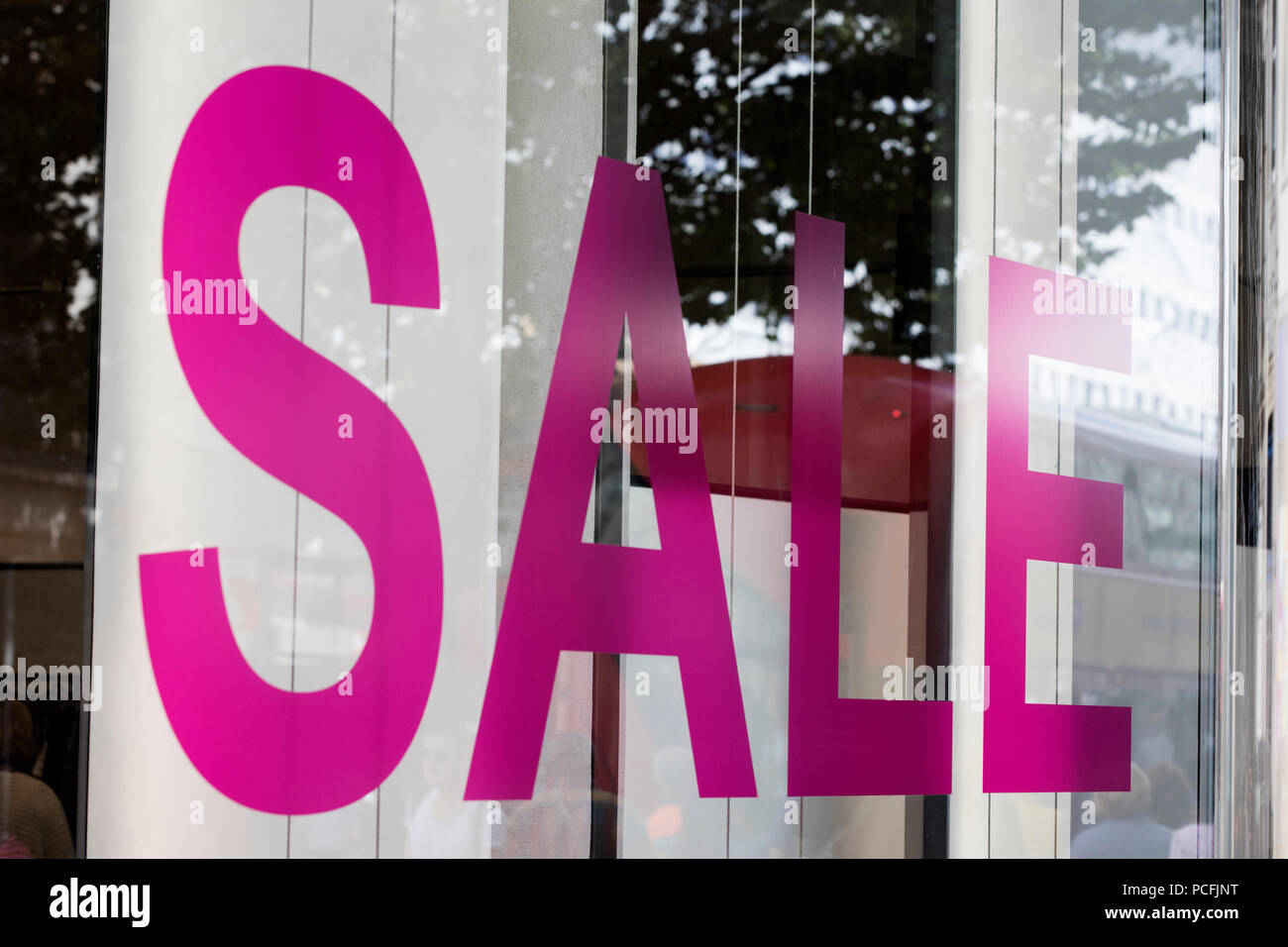 Sale sign in a retail shop window. shopping discount Stock Photo - Alamy