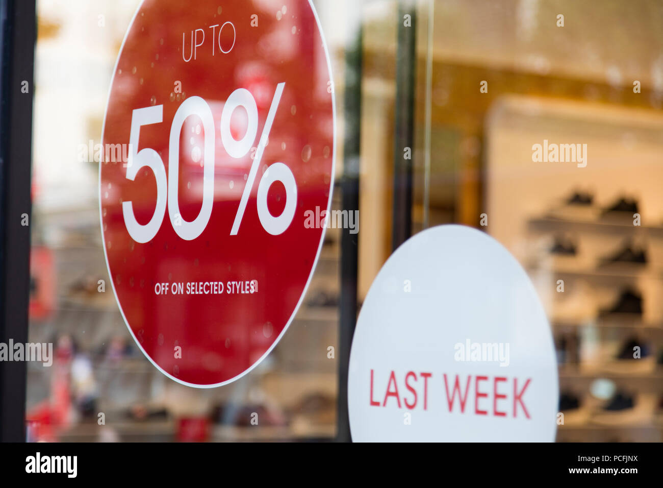Sale sign in a retail shop window. shopping discount Stock Photo - Alamy
