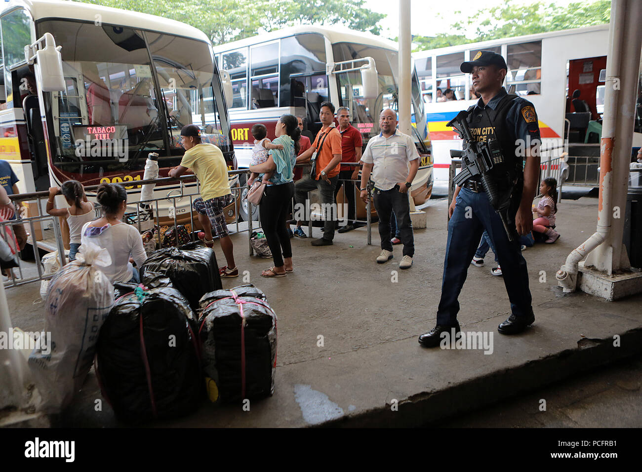 Quezon City, Philippines. 2nd Aug, 2018. A policeman patrols at a bus ...