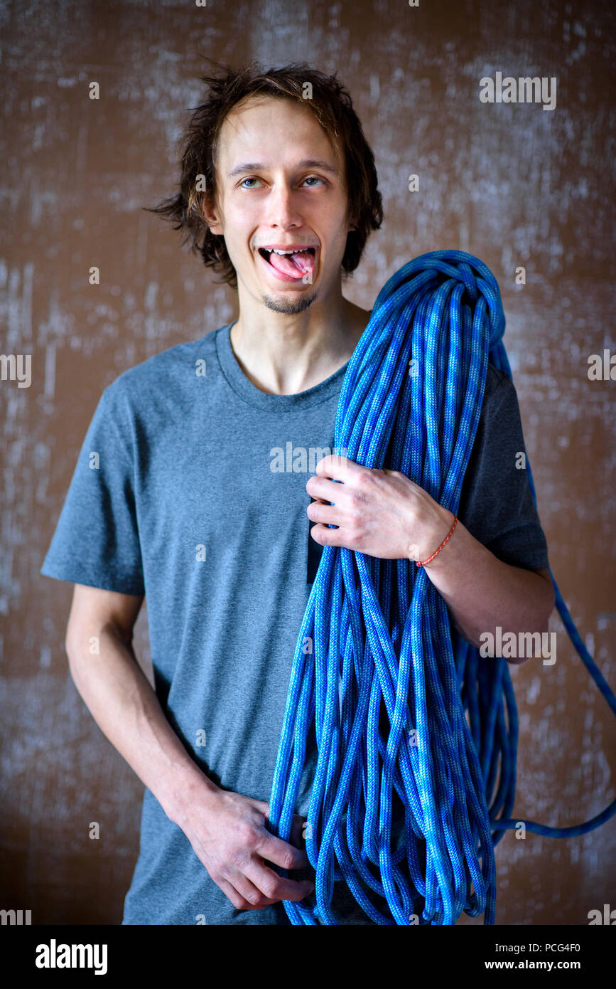 Sportman making funny face. Rock climber with a rope. People emotions ...
