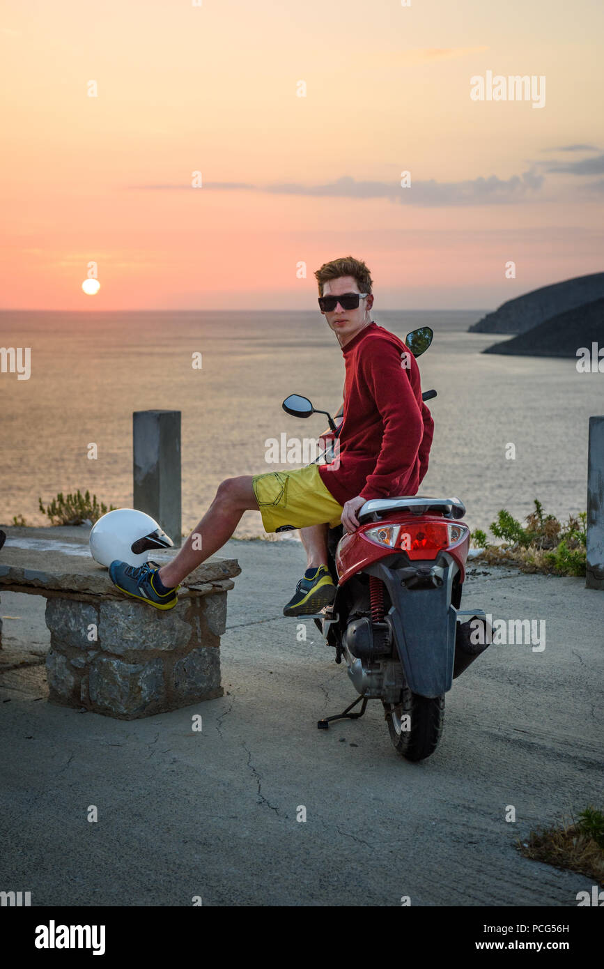 Portrait of Biker on the motorcycle hanging out near the beach ...