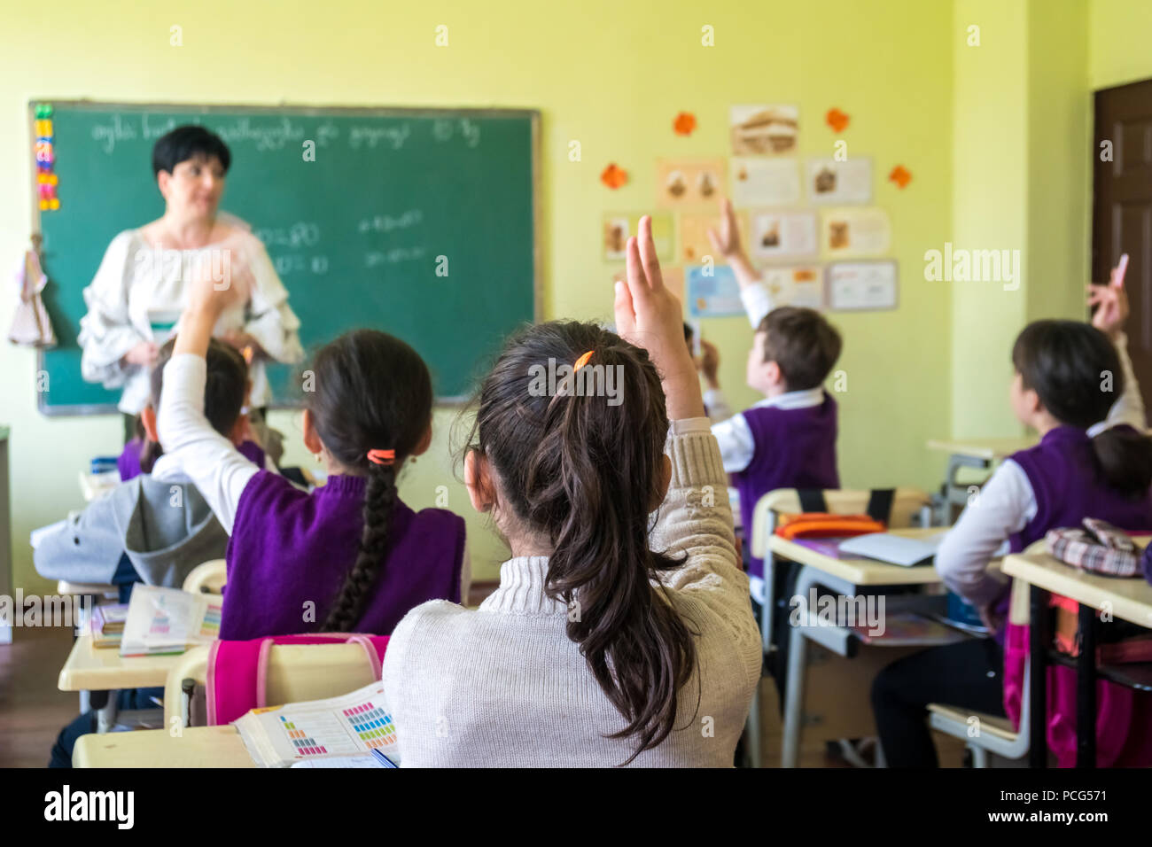 School children are participating actively in class. Lesson Stock Photo ...
