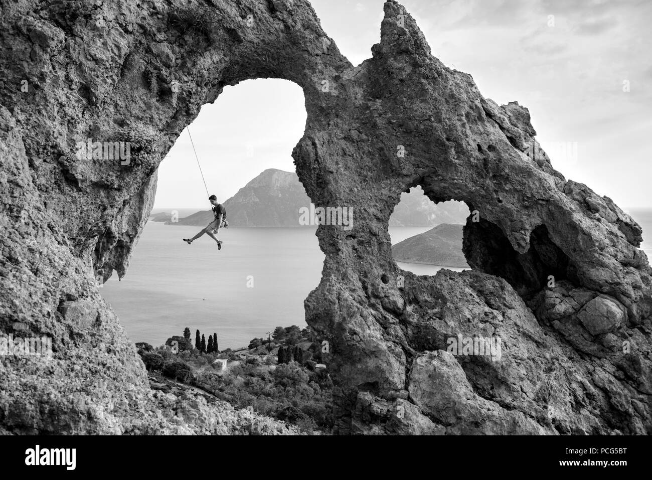 Famous rocks of Kalymnos Island, young man climbing a rock. Travel ...