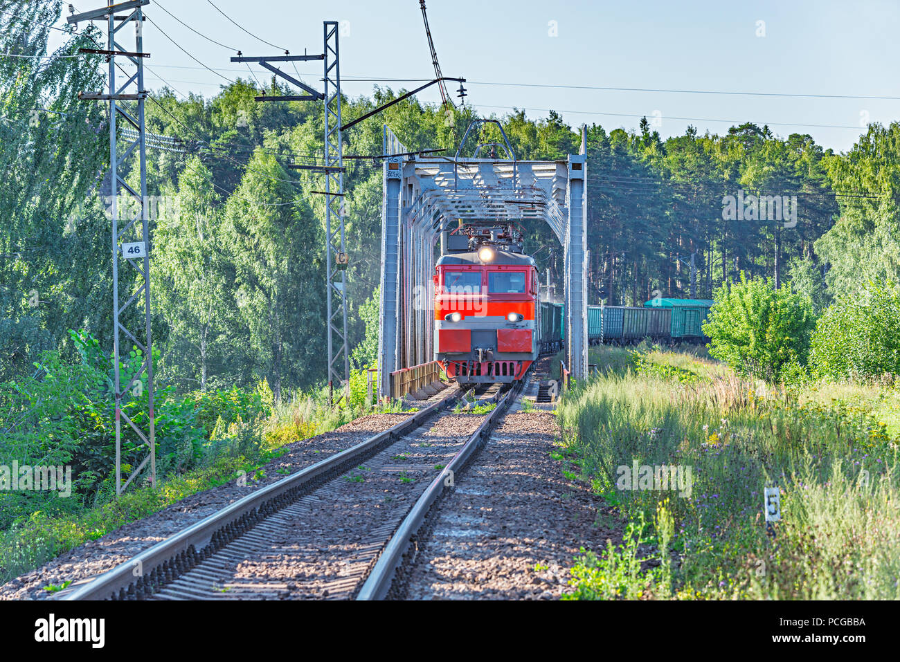 Long freight train moves through the bridge Stock Photo - Alamy