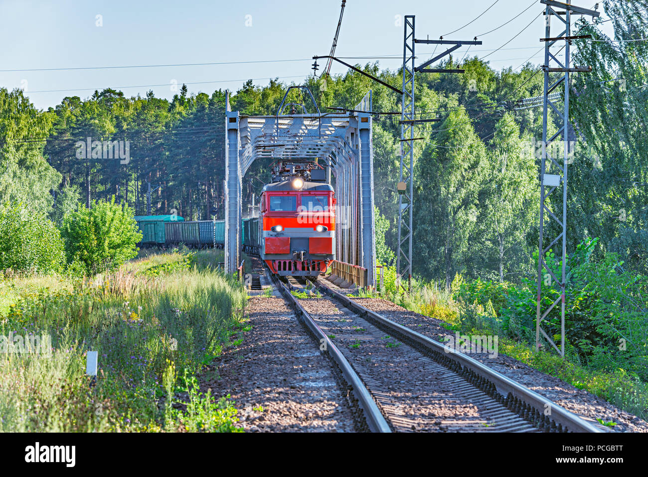 Long freight train moves through the bridge Stock Photo - Alamy