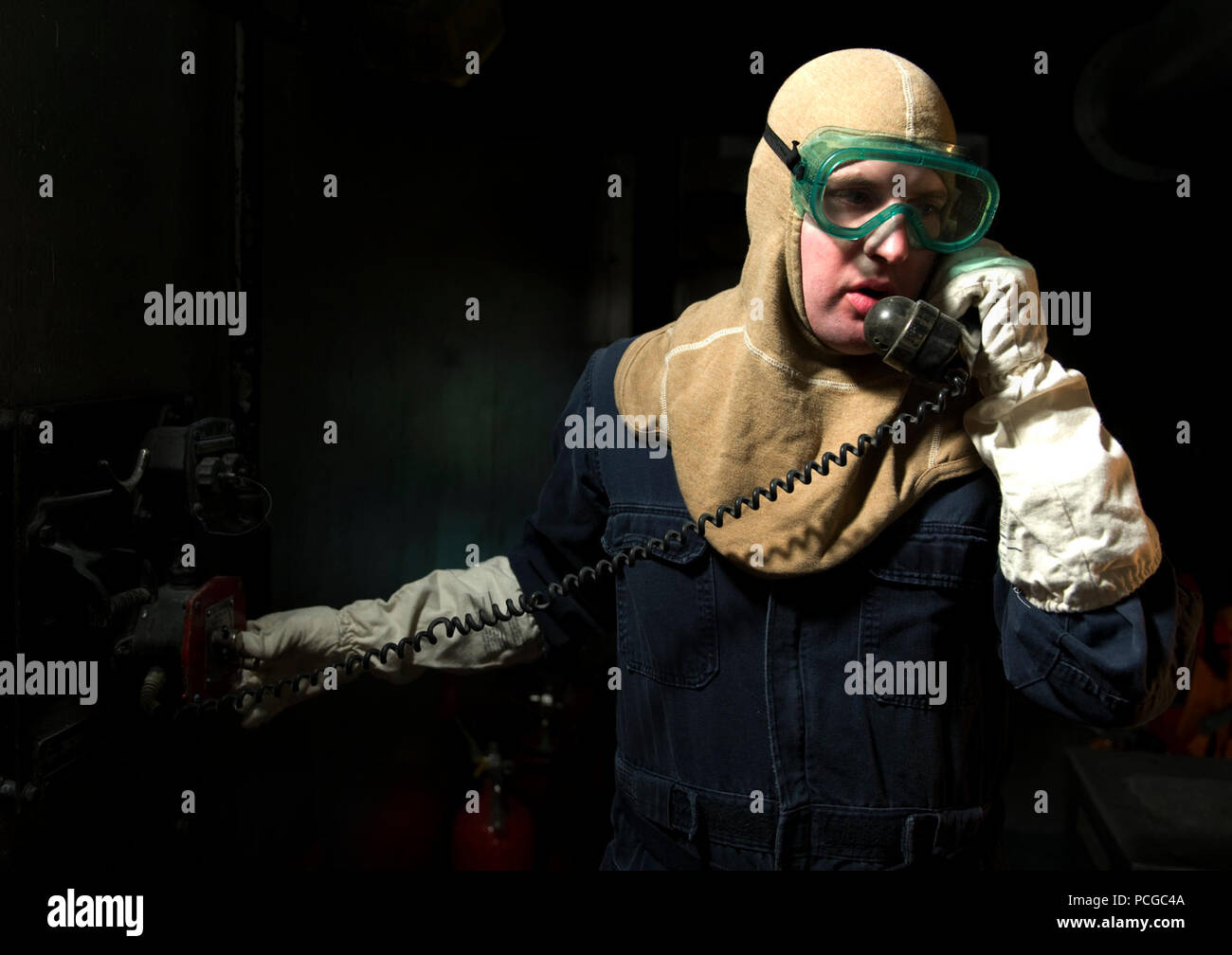 A student practices speaking through a sound powered telephone during ...