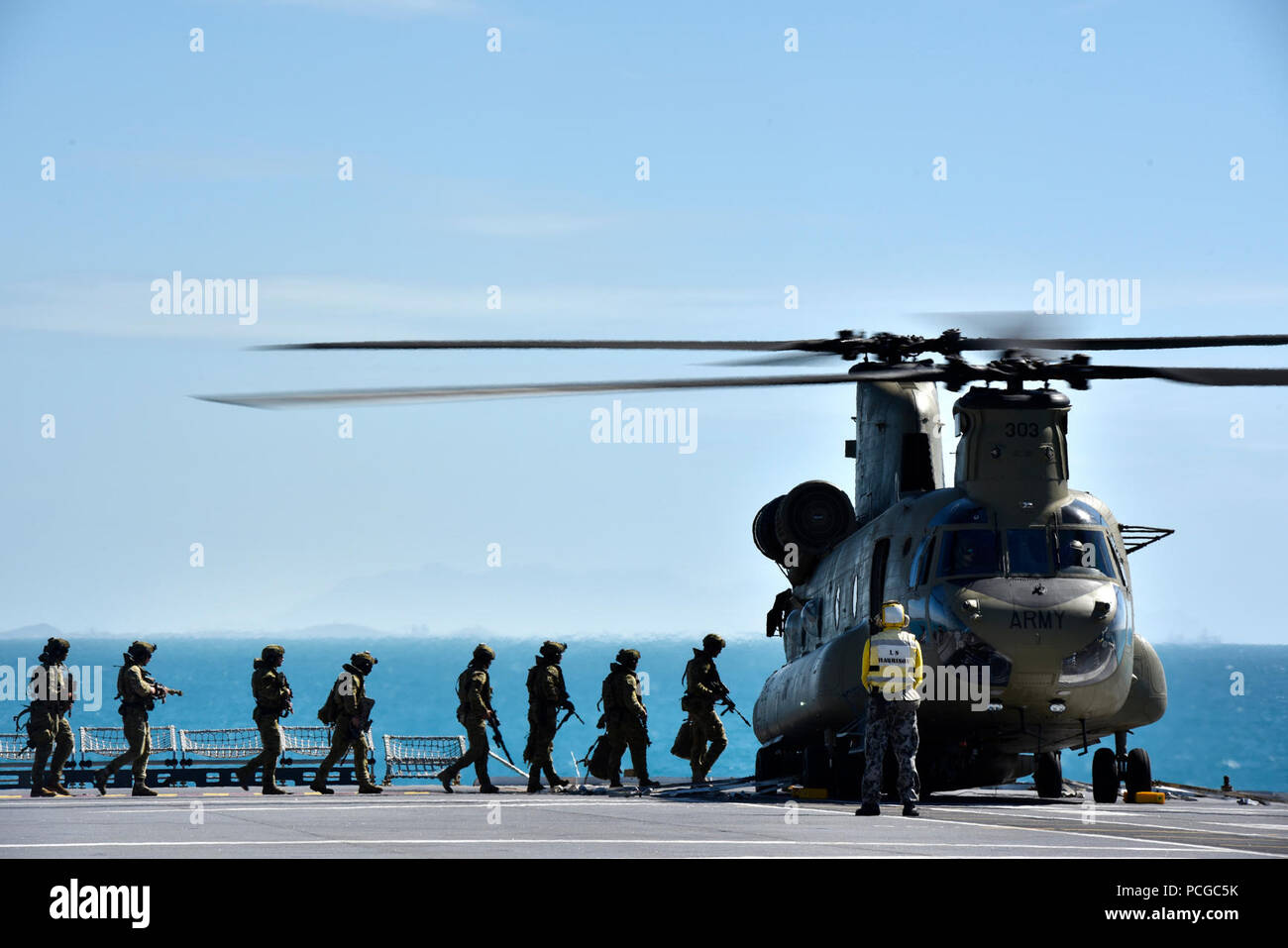 Members of the Australian Defence Force board a CH-53 helicopter during ...