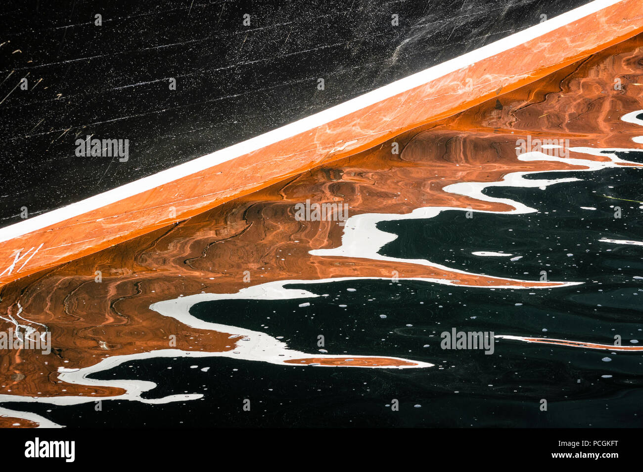 The reflection of red paint from the hull of Bluenose II appears like ...