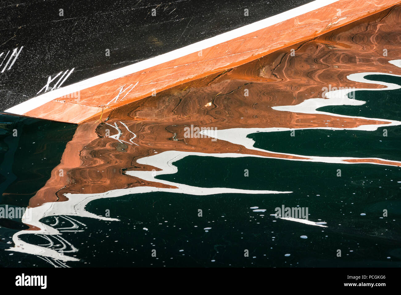 The reflection of red paint from the hull of Bluenose II appears like ...