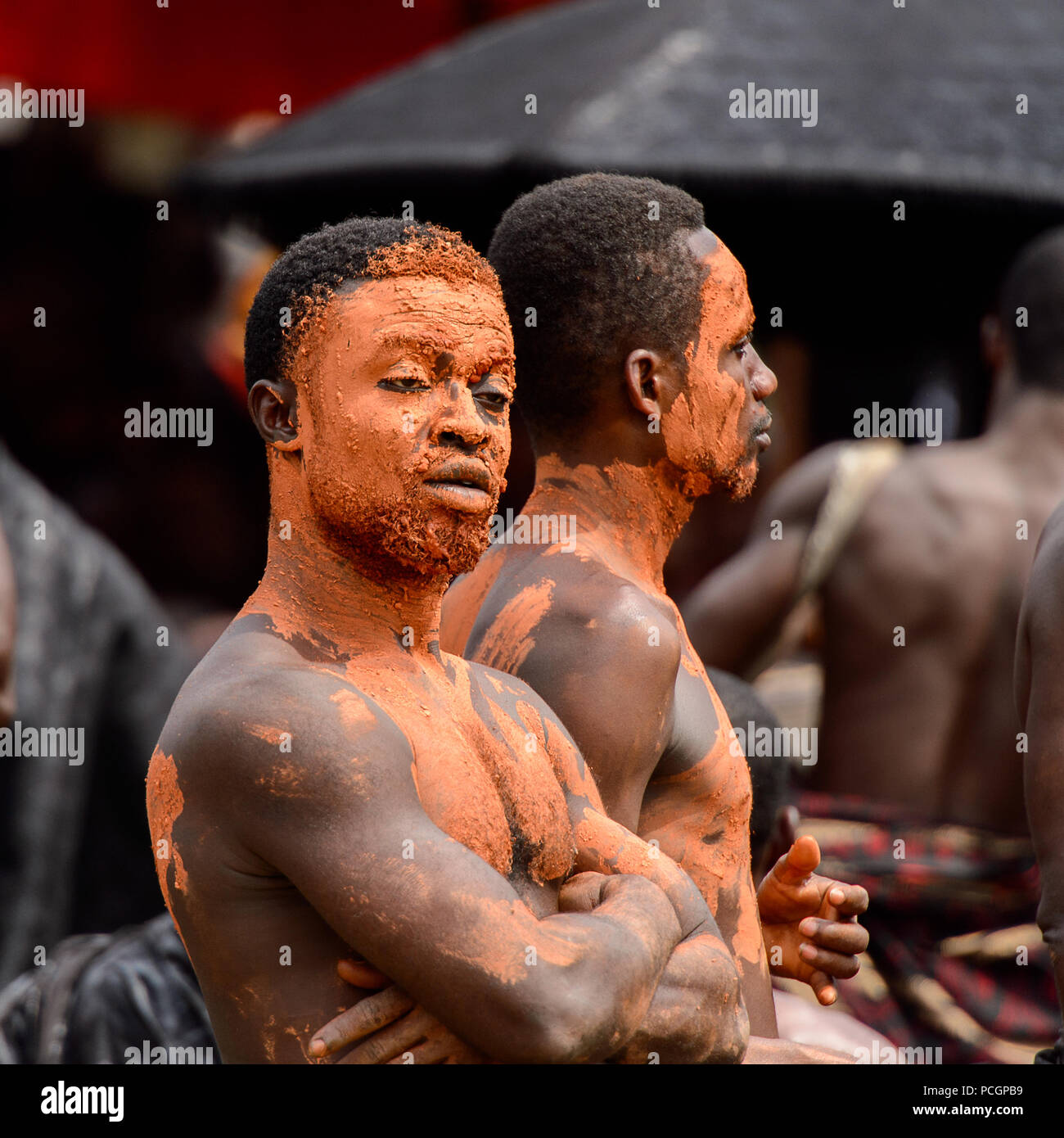 KUMASI, GHANA - JAN 16, 2017: Unidentified Ghanaian man in orange mud ...