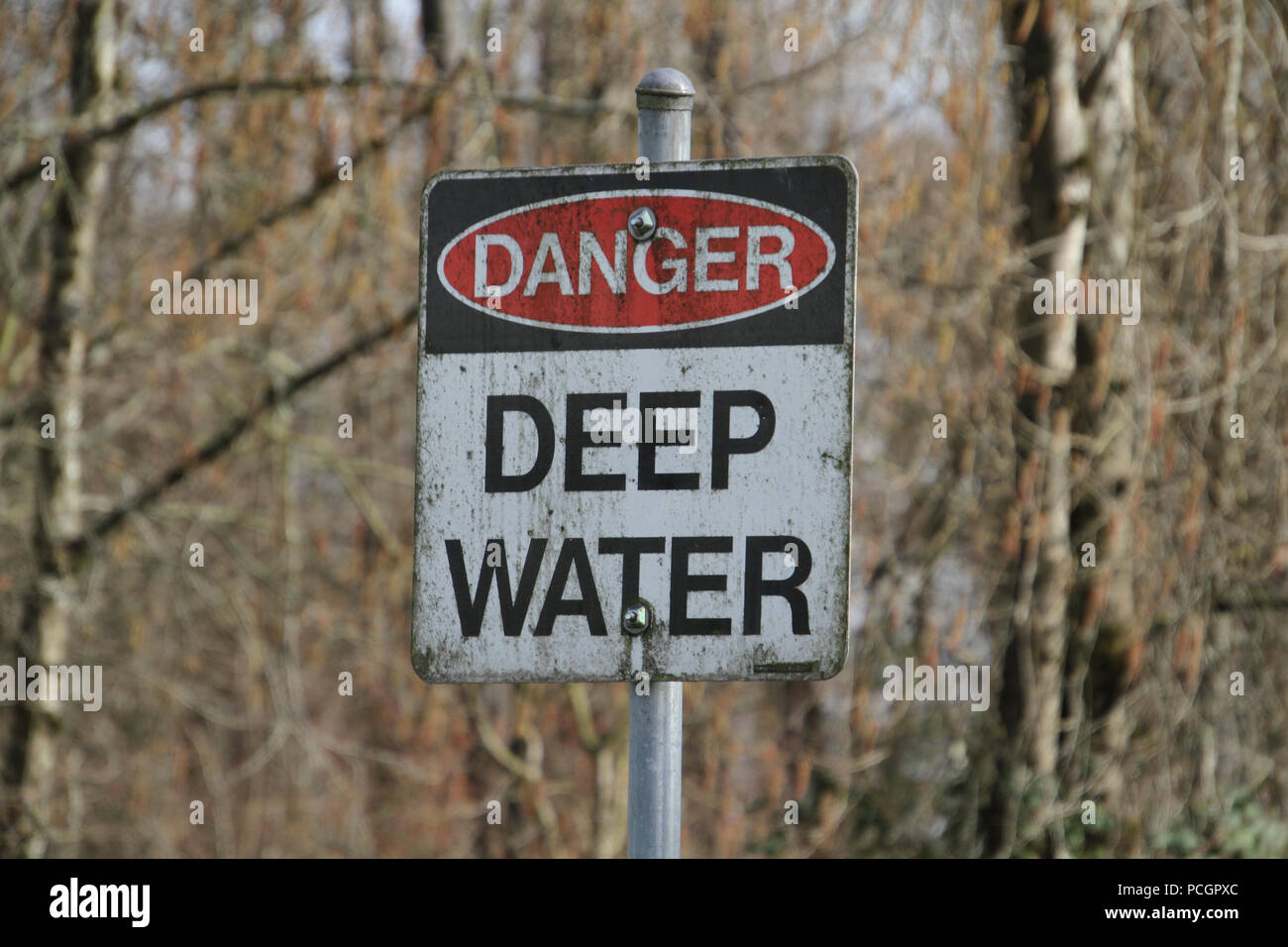 A danger deep water sign on a metal post in the woods Stock Photo - Alamy