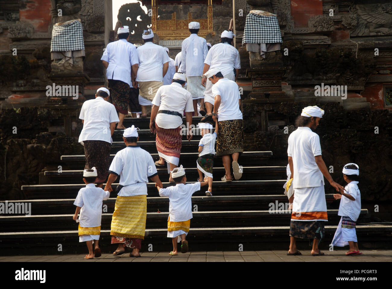 A Hindu temple procession, men and boys on the temple steps, Ubud, Bali ...