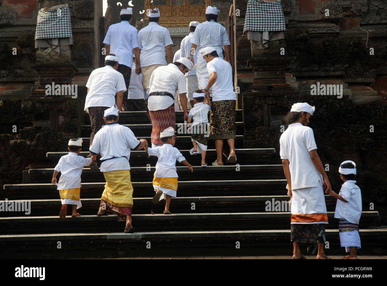 A Hindu temple procession, men and boys on the temple steps, Ubud, Bali ...