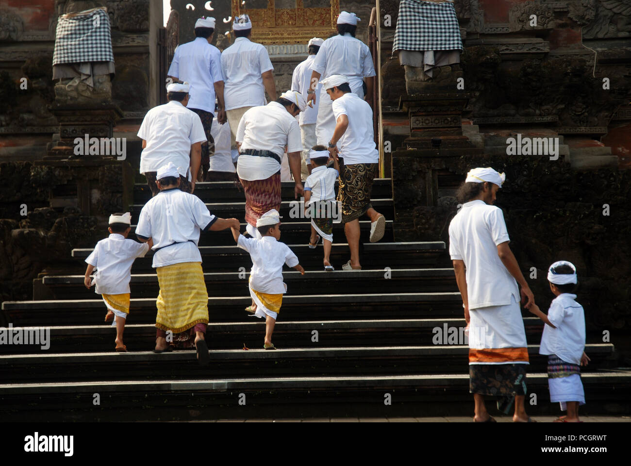 A Hindu temple procession, men and boys on the temple steps, Ubud, Bali ...