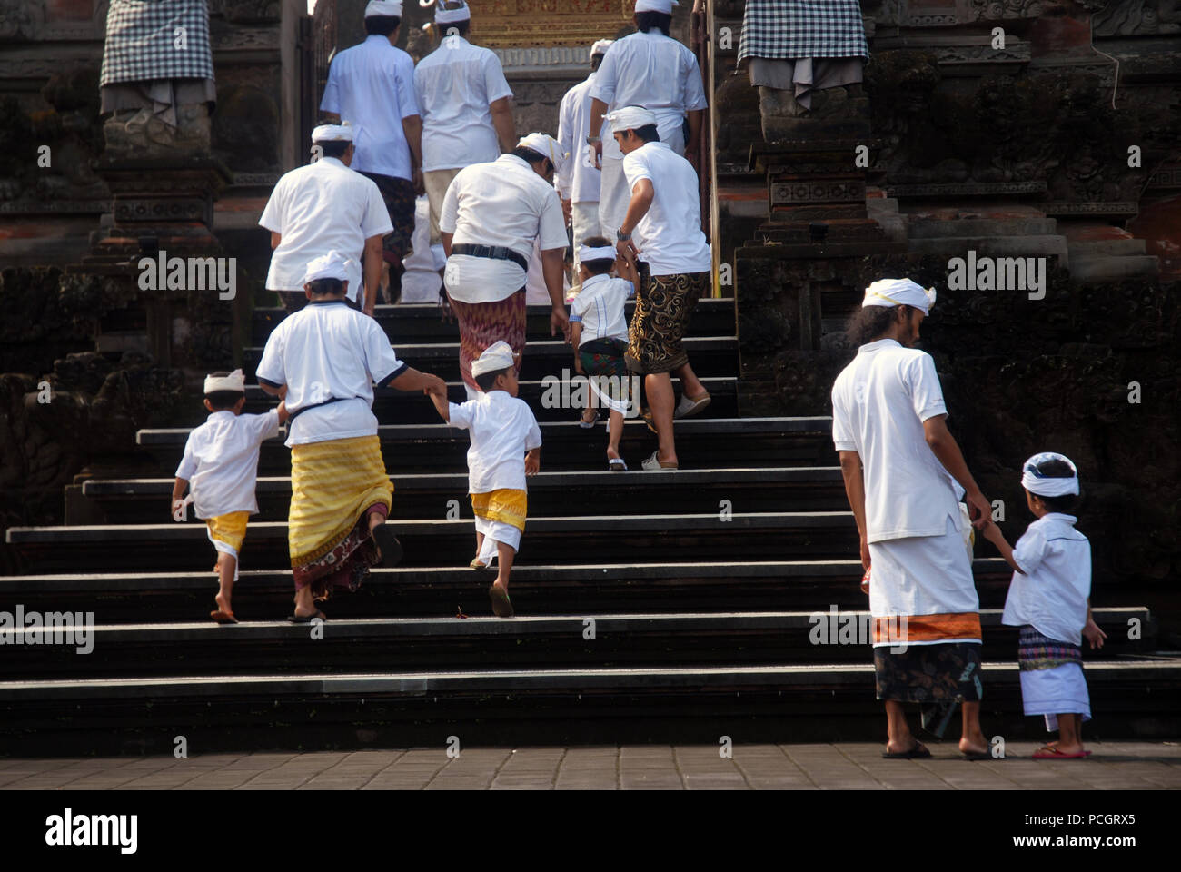 A Hindu temple procession, men and boys on the temple steps, Ubud, Bali ...