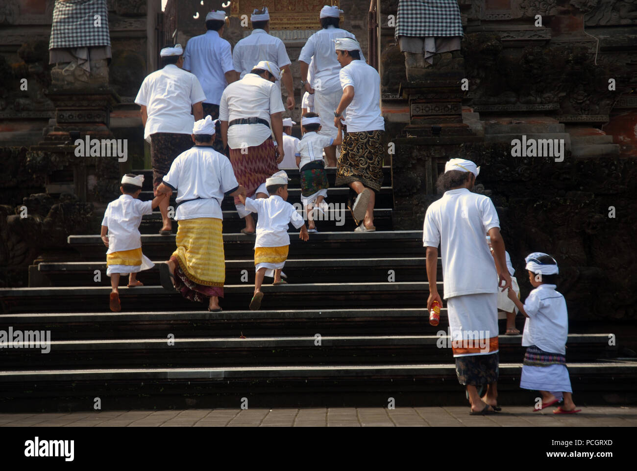 A Hindu temple procession, men and boys on the temple steps, Ubud, Bali ...