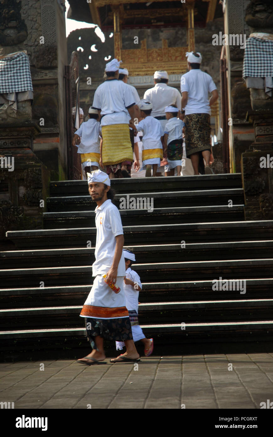A Hindu temple procession, men and boys on the temple steps, Ubud, Bali ...