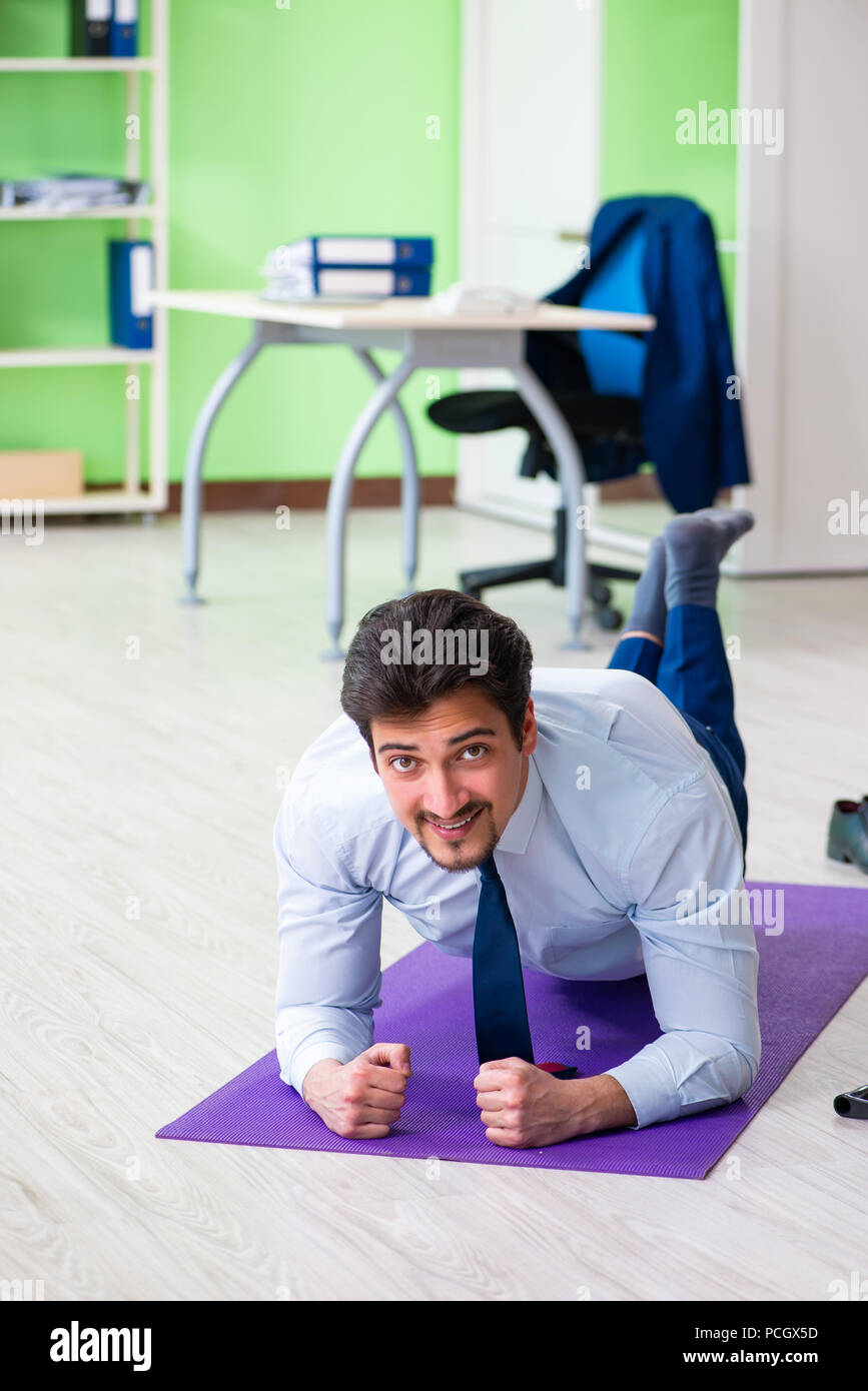 Employee doing exercises during break at work Stock Photo - Alamy