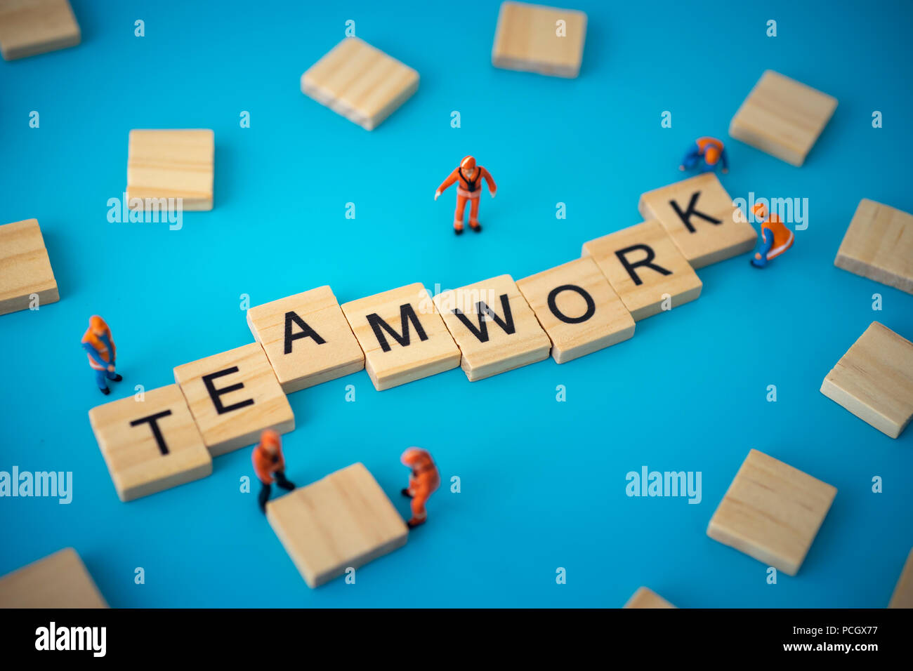 Business concept of teamwork. Workers arranging wood with text Stock ...