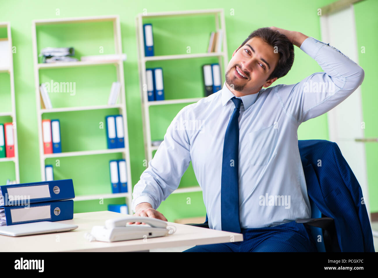 Employee doing exercises during break at work Stock Photo - Alamy