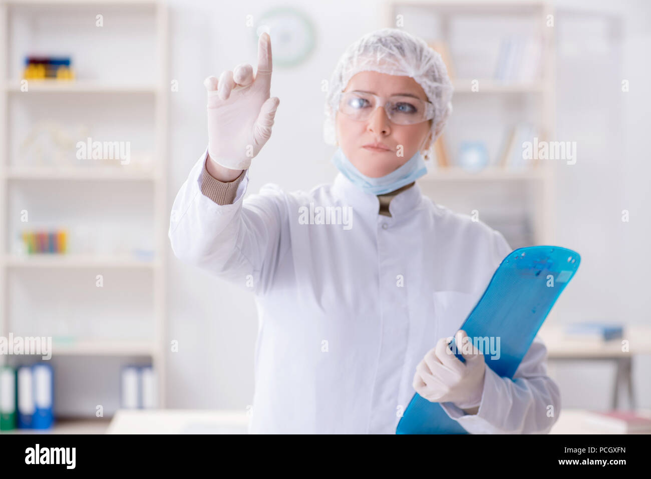 Woman doctor pressing buttons in lab Stock Photo - Alamy