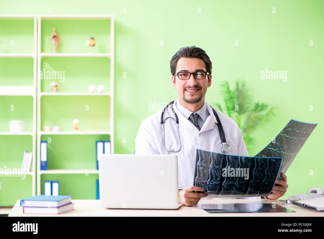 Doctor radiologist looking at x-ray scan in hospital Stock Photo - Alamy