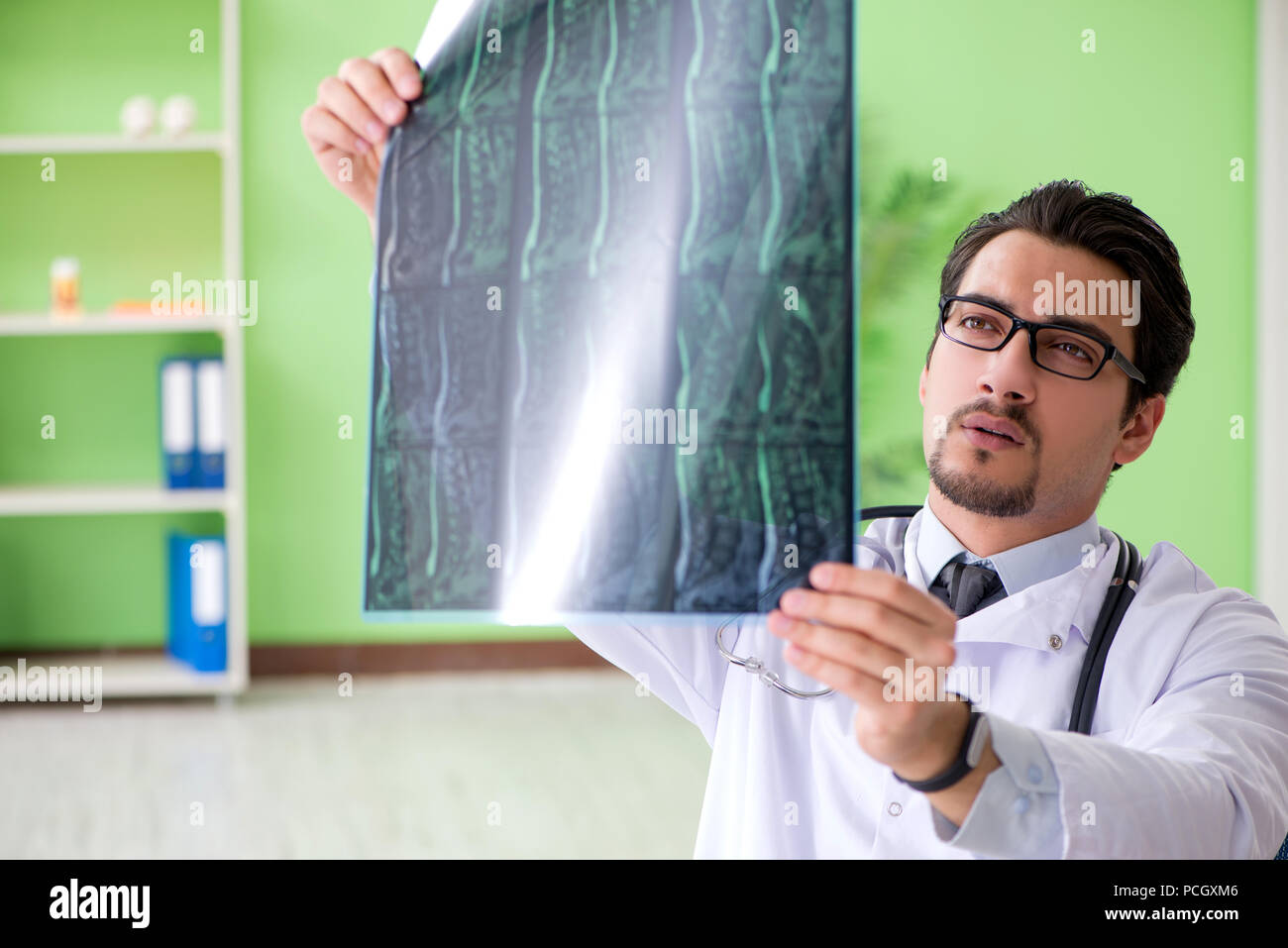 Doctor radiologist looking at x-ray scan in hospital Stock Photo - Alamy