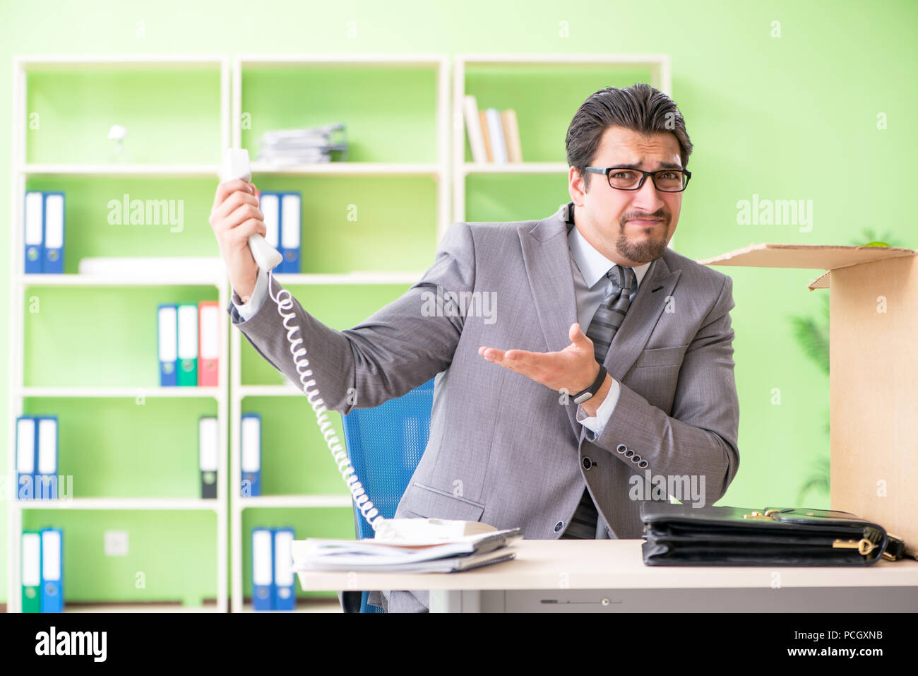 Male employee collecting his stuff after redundancy Stock Photo - Alamy