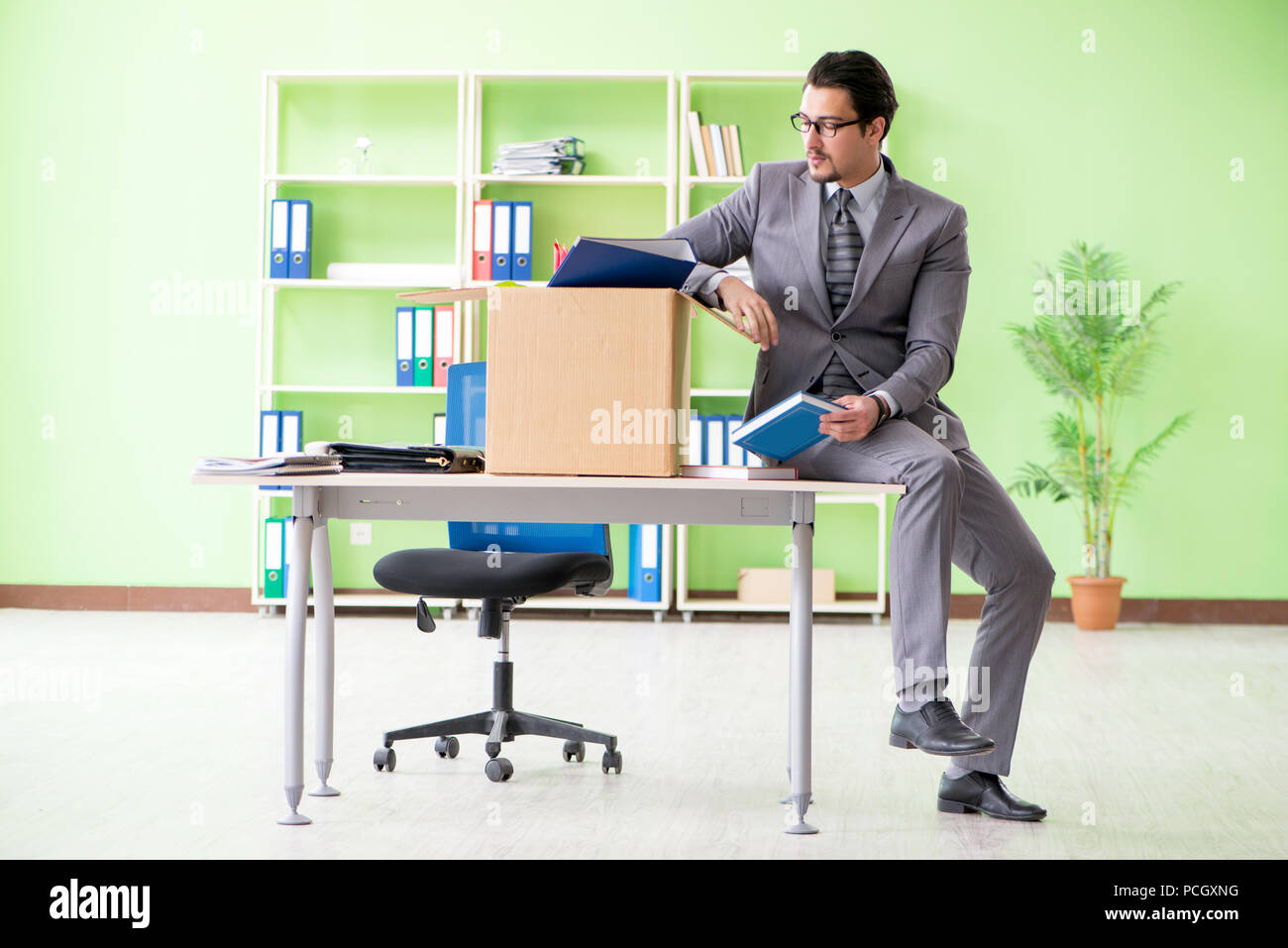 Male employee collecting his stuff after redundancy Stock Photo - Alamy