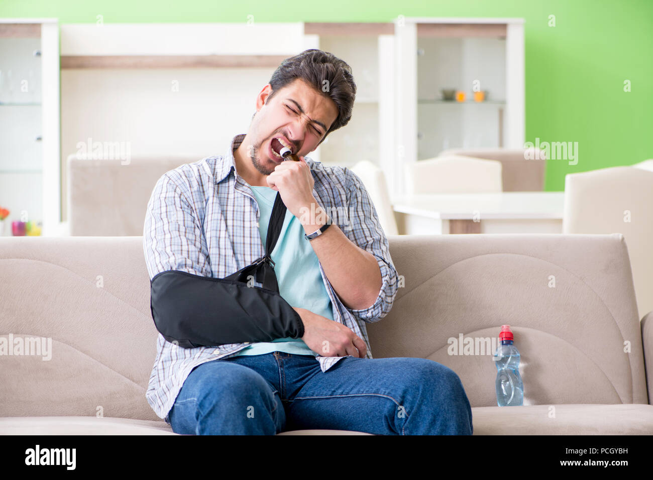 Young student man with hand injury sitting on the sofa Stock Photo - Alamy