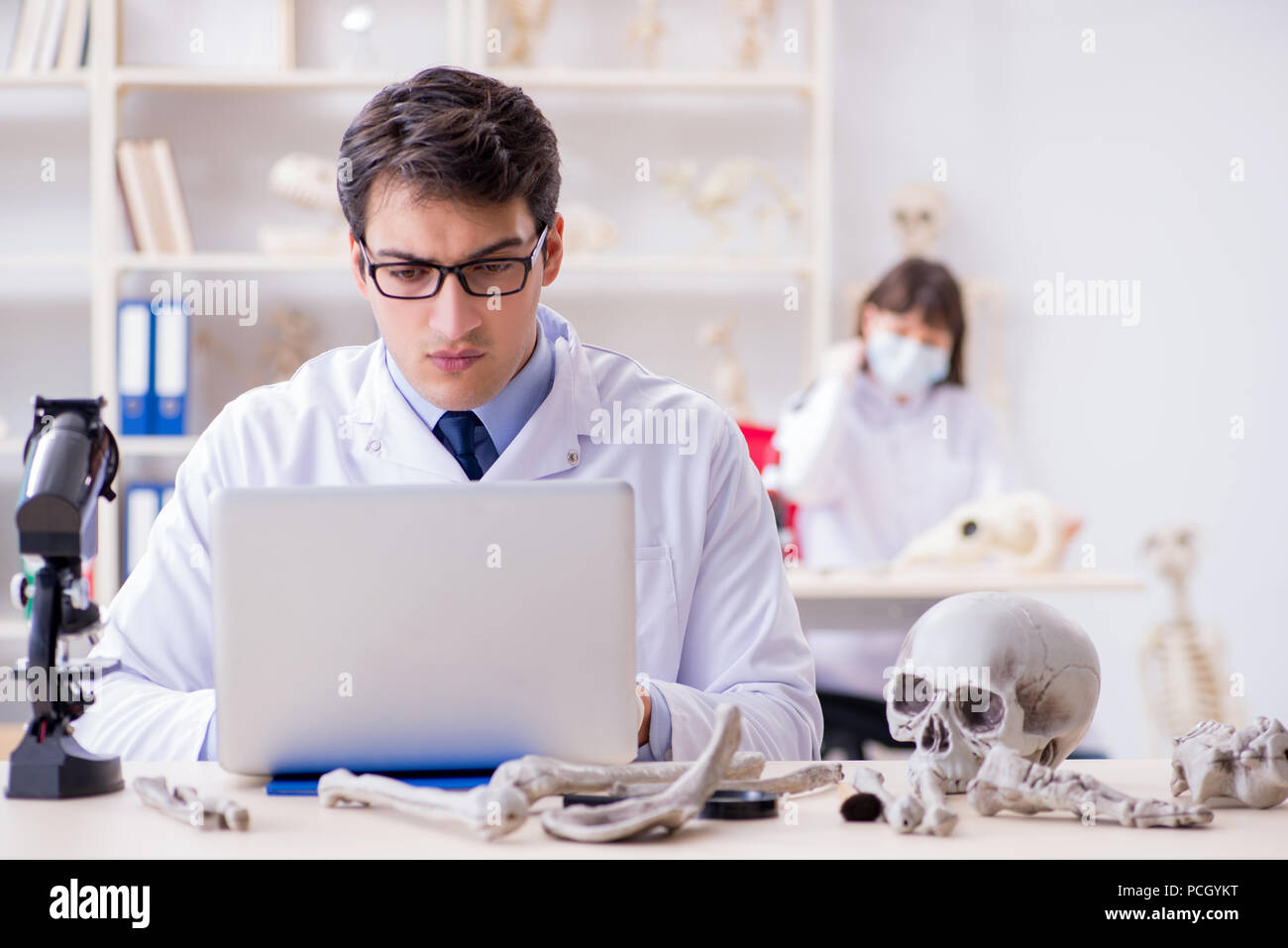 Professor studying human skeleton in lab Stock Photo - Alamy