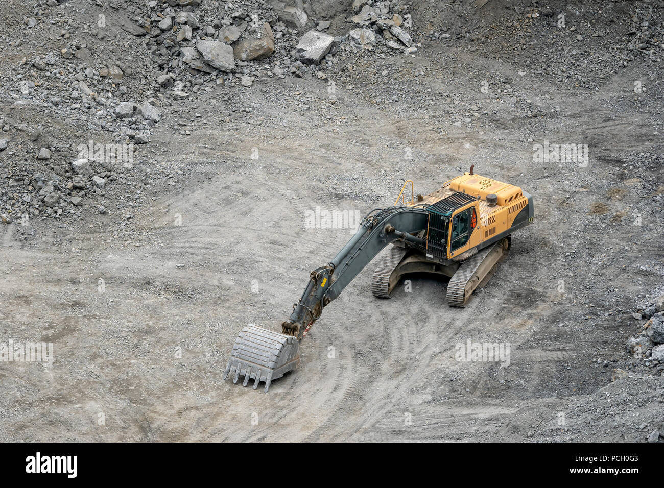 Mining in the granite quarry. Working mining machine - digger. Mining ...