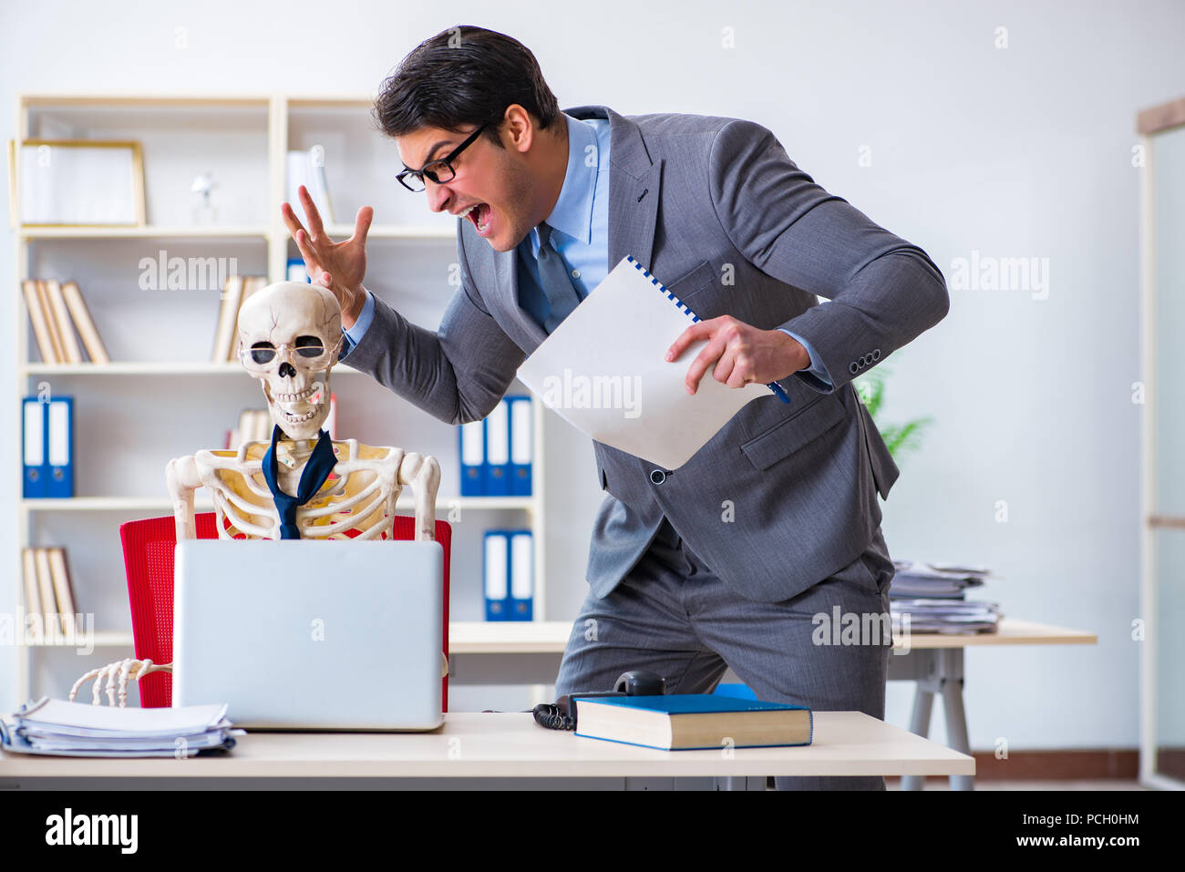 Angry boss yelling at his skeleton employee Stock Photo - Alamy