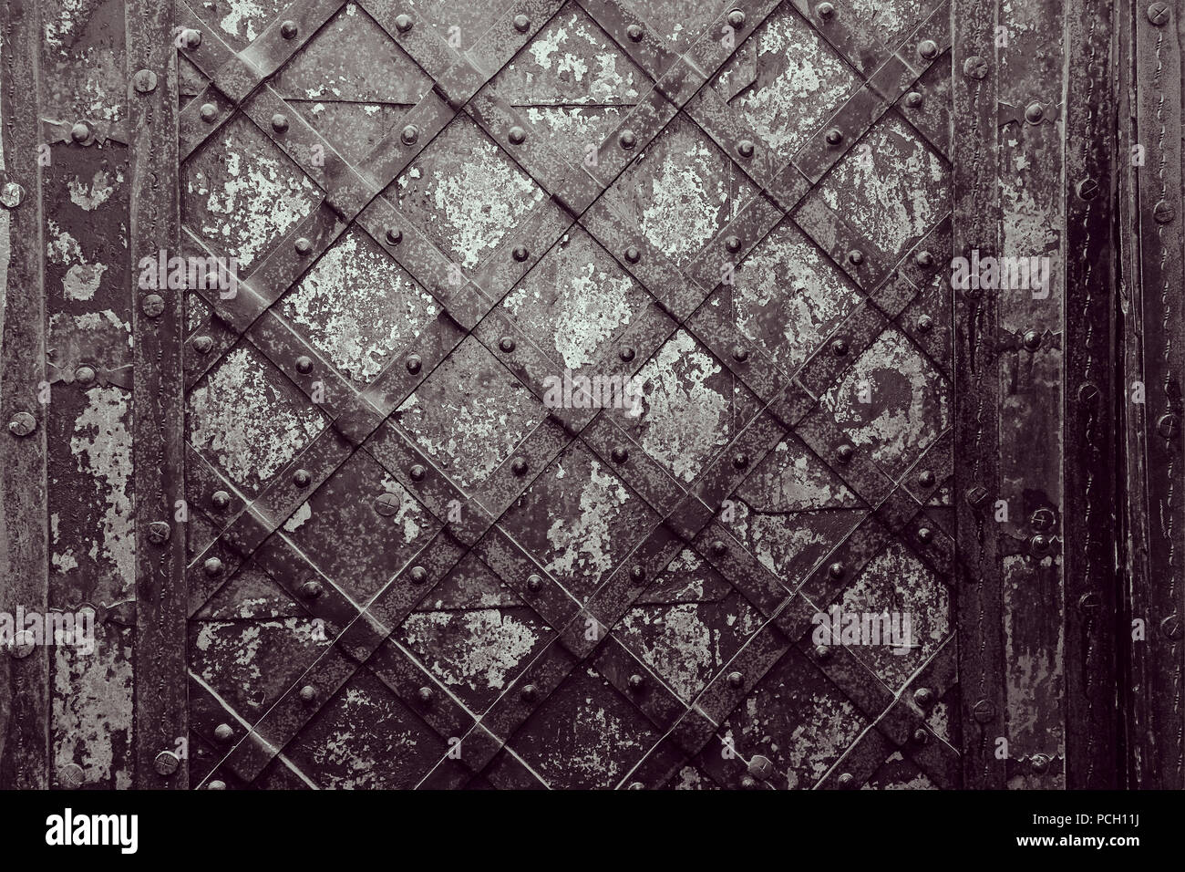 metal doors with forged bars, An old wrought iron door studded with ...