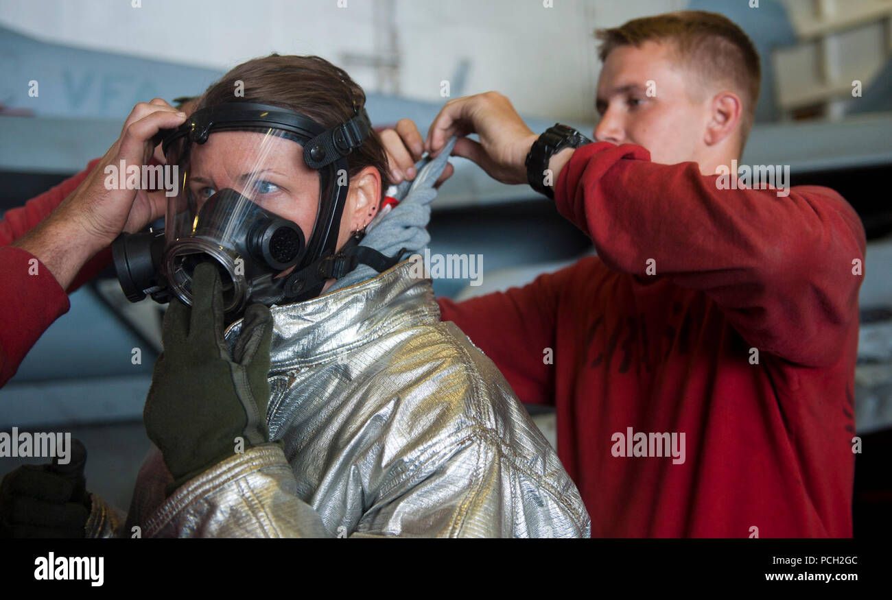 PACIFIC OCEAN (Feb. 23, 2012) A Tiger is assisted in donning a self ...